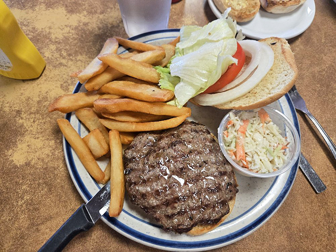 This isn't just a burger &ndash; it's a hand-formed masterpiece of beef perfection, accompanied by golden fries and fresh coleslaw.