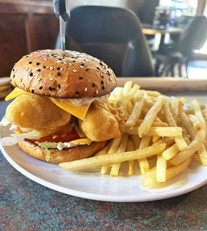 The hand-breaded cod sandwich arrives like an edible work of art &ndash; golden-battered fish peeking from a sesame bun alongside a mountain of fries.