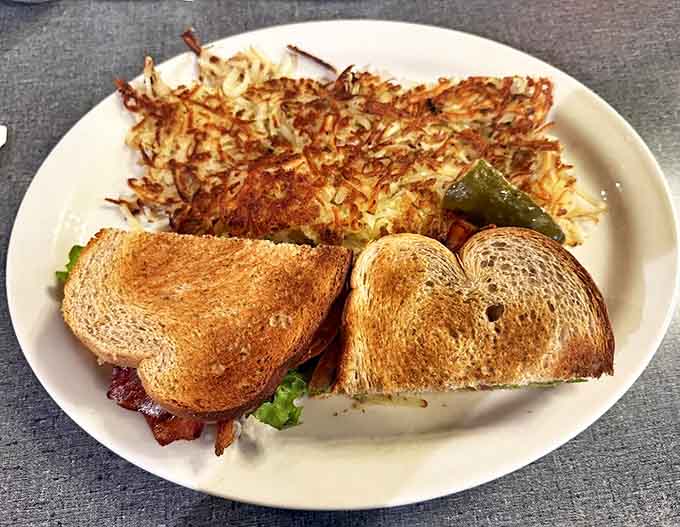 Golden-crisp hash browns share the spotlight with a perfectly toasted BLT – a simple combination elevated to art form.