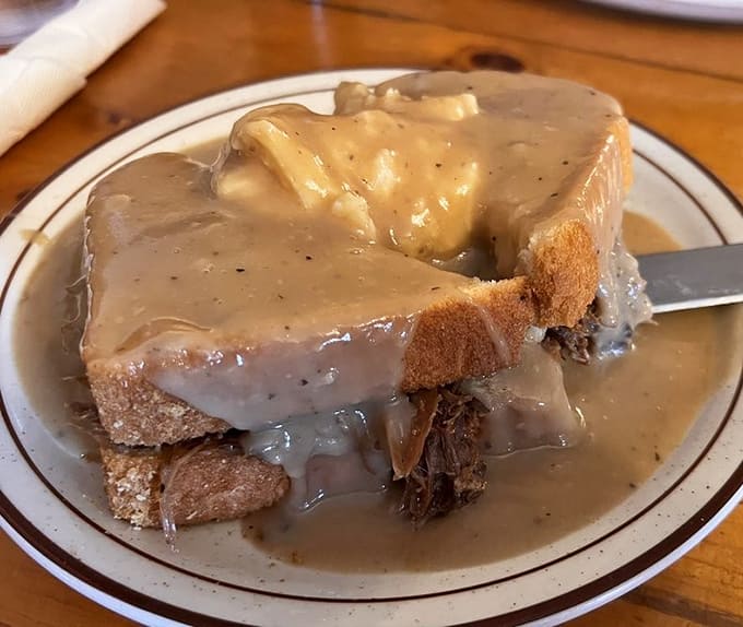 This hot beef sandwich isn't just a meal—it's a gravy-soaked hug on a plate that makes you want to call your mother.