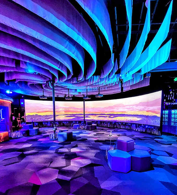 The immersive projection room wraps you in a 360-degree sunset that makes actual sunsets seem like they're not really trying.