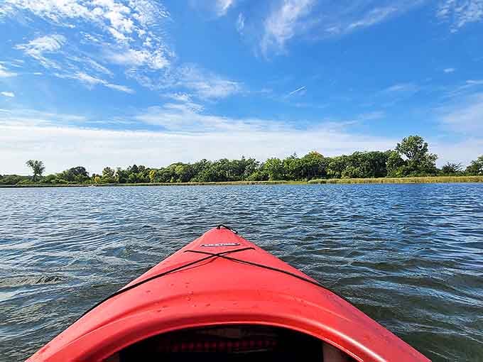 Kayaking on lake: That red kayak cutting through mirror-like waters is basically saying, "Your office cubicle can wait &ndash; adventure is calling."