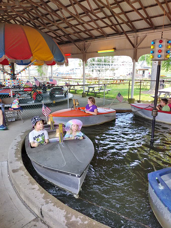 Tiny captains navigate their vessels with serious determination in the kiddie boat ride, creating ripples of joy in this miniature maritime adventure.