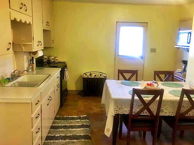 Cheerful yellow walls brighten this practical kitchen where modern appliances meet vintage charm &ndash; the perfect blend of then and now.