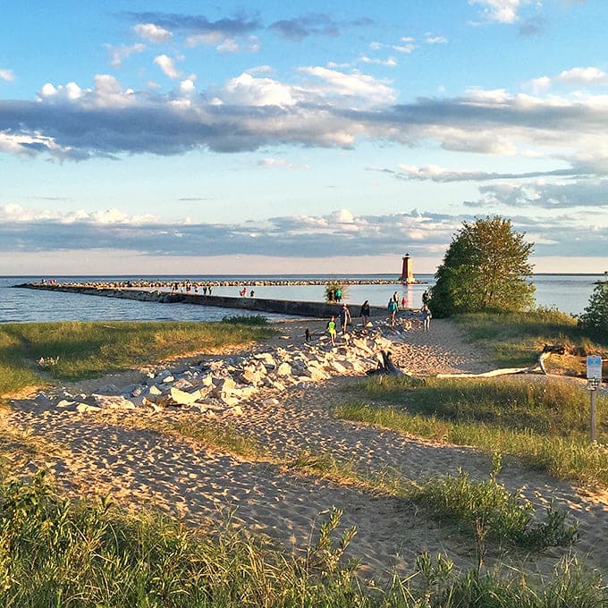 Golden hour transforms Manistique's shoreline into nature's masterpiece, where even amateur photographers suddenly look like professionals.
