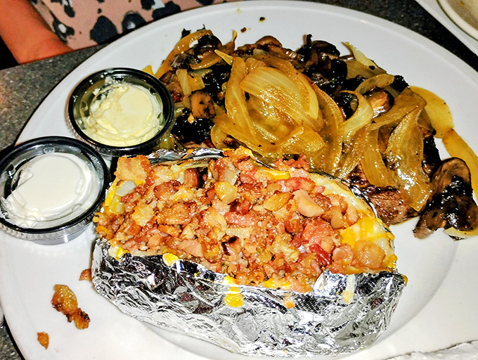 Loaded Potato: Foil-wrapped perfection topped with enough bacon to make vegetarians reconsider their life choices. Pure comfort in every bite.