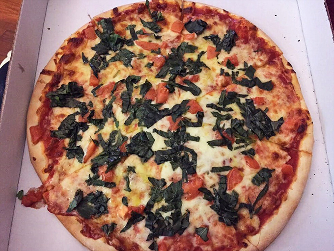 Fresh basil and tomato dance across this pie like old friends reuniting after too long apart.