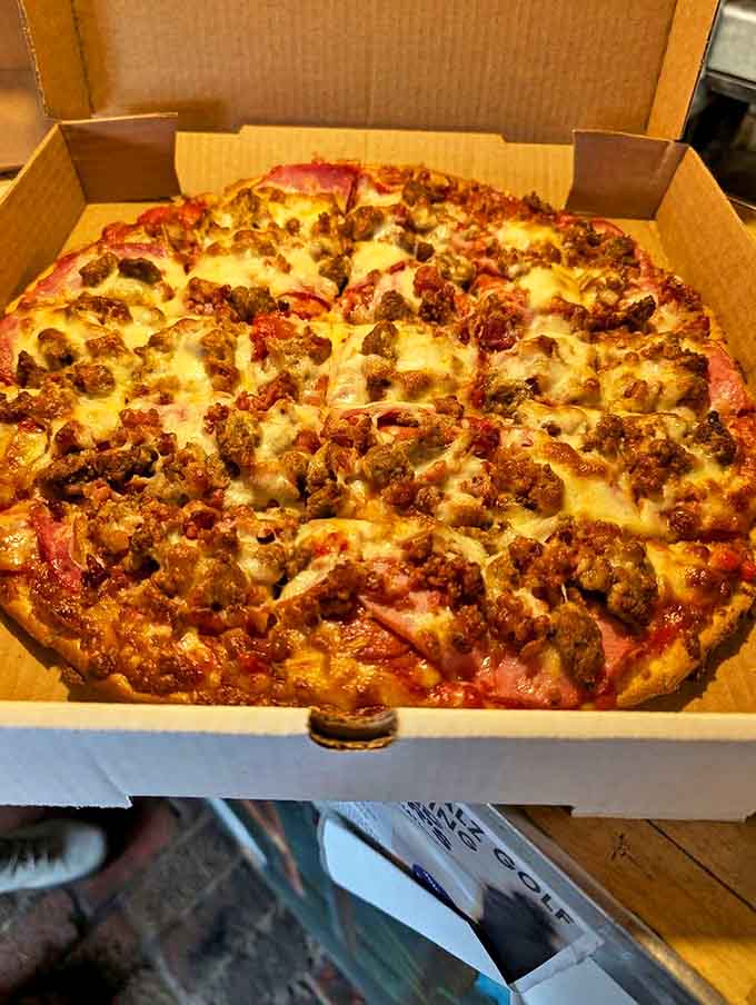 Meat lover's dream realized: this hearty pizza showcases the generous toppings and perfect cheese-to-sauce ratio that keeps customers coming back.