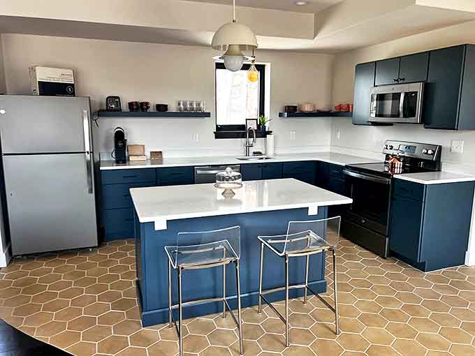 This sleek modern kitchen with its navy cabinets and hexagonal tile proves that historic buildings can embrace contemporary style without losing character.