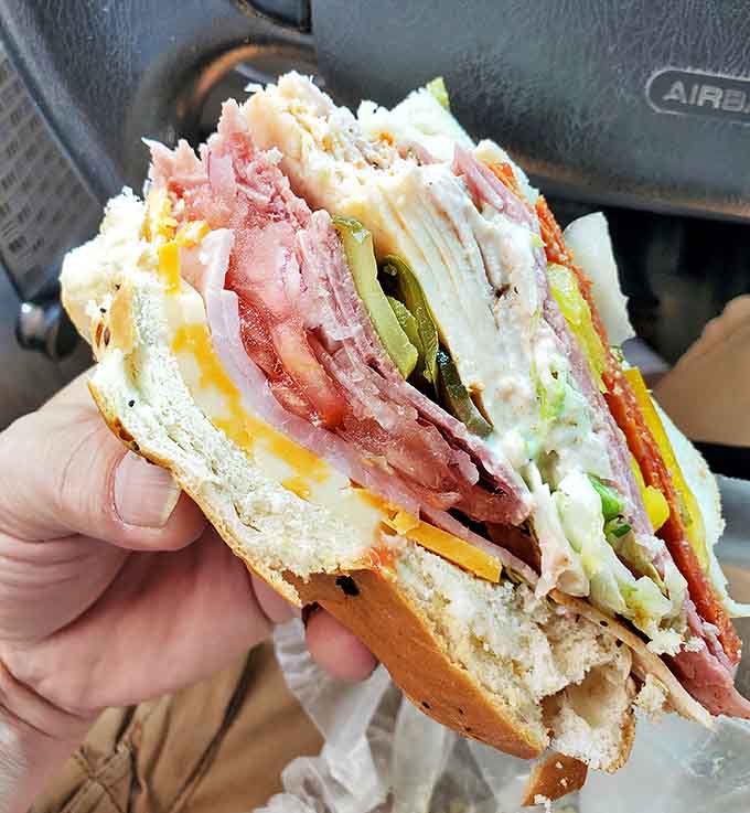 Behold the Monster in all its glory, a sandwich so magnificently overstuffed it makes you question whether your mouth can actually open that wide.