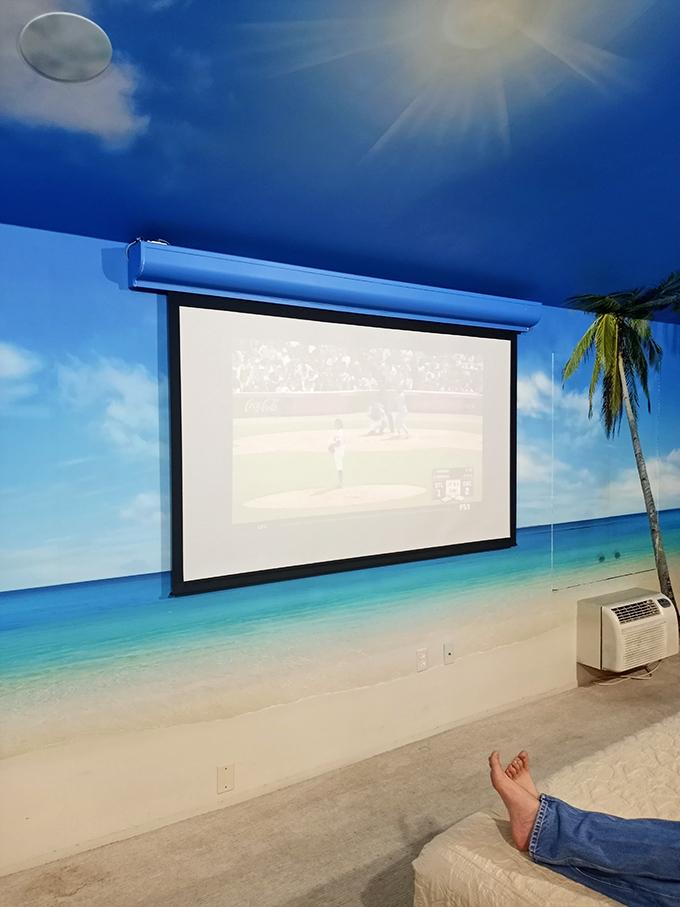 Transport yourself to a tropical paradise with this beach-themed movie room – all the vacation vibes without the sunburn!