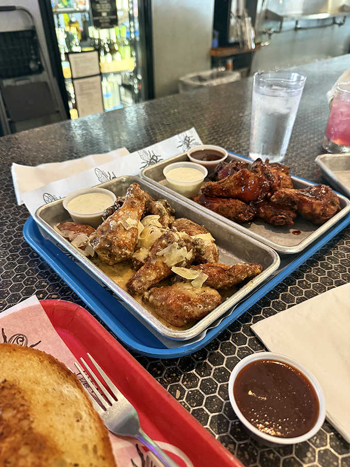 Two trays of wing perfection &ndash; one glistening with parmesan, the other glazed in sticky-sweet sauce &ndash; demanding to be devoured.