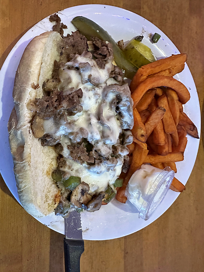 This isn't just a Philly Cheese Steak &ndash; it's a masterpiece of tender beef, melted cheese, and saut&eacute;ed veggies that demands to be devoured alongside those perfectly crispy sweet potato fries.
