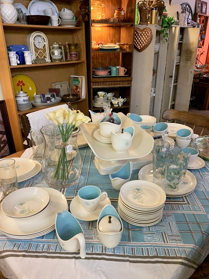 Delicate blue and cream dishware arranged with loving care &ndash; each teacup and saucer a survivor of countless conversations, celebrations, and quiet morning rituals.