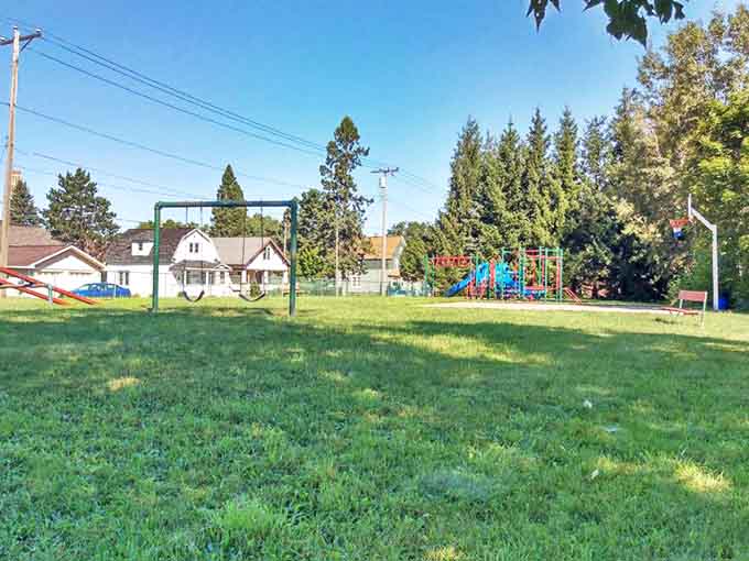 This playground proves that small-town parks still know how to give kids a proper childhood, complete with swings and wide-open spaces for running wild.