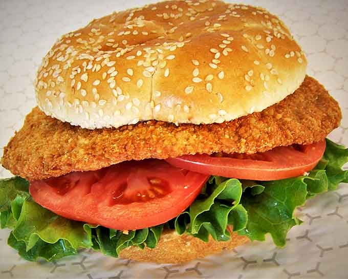 The legendary pork tenderloin sandwich – where the meat extends so far beyond the bun that it needs its own zip code. Crispy perfection meets soft bread.