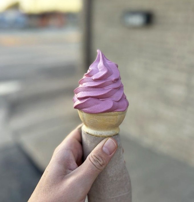 A perfect raspberry swirl defying both gravity and sadness &ndash; this vibrant purple treat practically demands to be photographed before it's devoured.