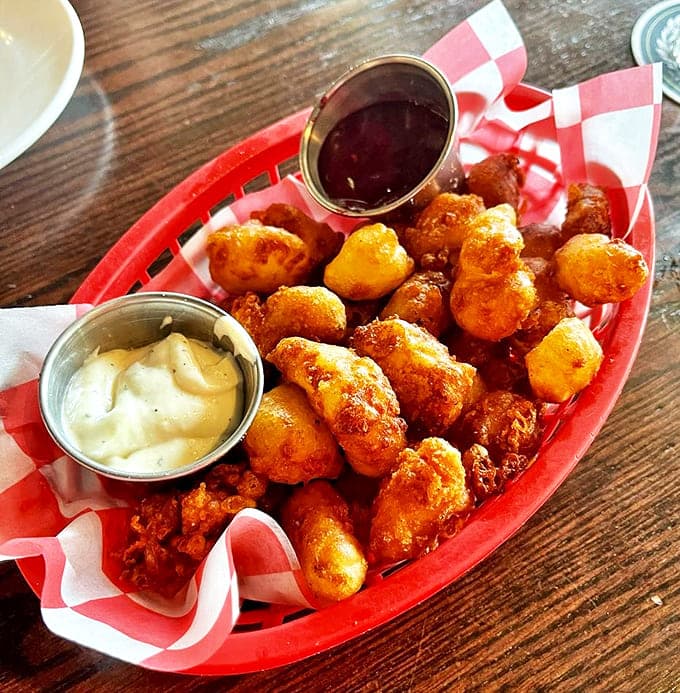 Golden-fried cheese curds that would make Wisconsin proud &ndash; crispy outside, molten inside, with dipping sauces that elevate every bite.