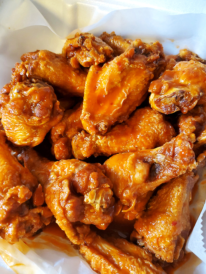 Honey BBQ wings glistening with that perfect sauce-to-meat ratio &ndash; napkins required, no exceptions.