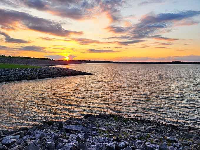 Golden hour transforms Carlyle Lake into a painter's dream, where water and sky merge in a spectacular display of nature's artistry.