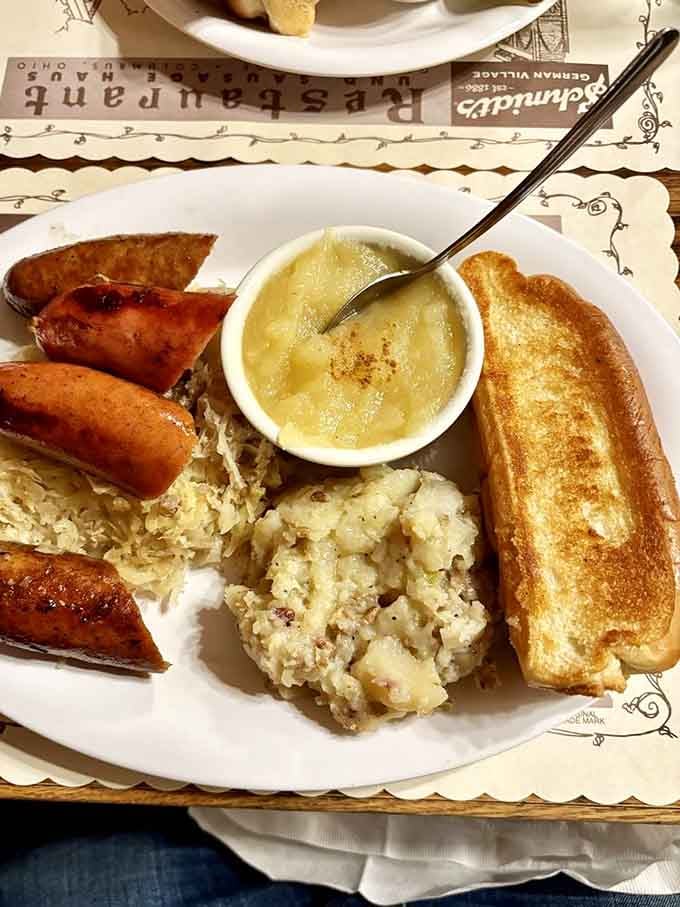 Sausages, sauerkraut, and German potato salad unite on one plate like the Avengers of comfort food, ready to save you from hunger.