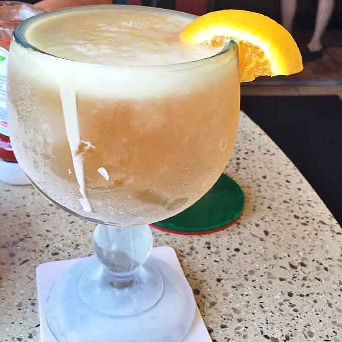 The legendary schooners arrive frosty and imposing, their icy exteriors promising refreshment that pairs perfectly with piping hot pizza.