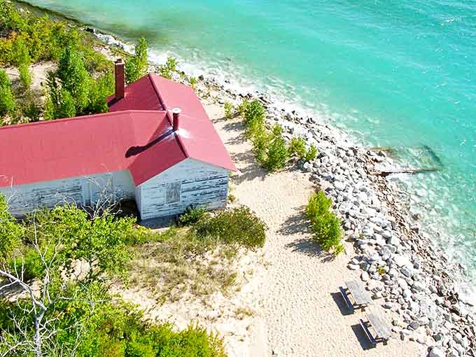 The lighthouse complex whispers stories of storms weathered and ships saved, its red-roofed buildings a cheerful contrast to Lake Michigan's sometimes temperamental moods.