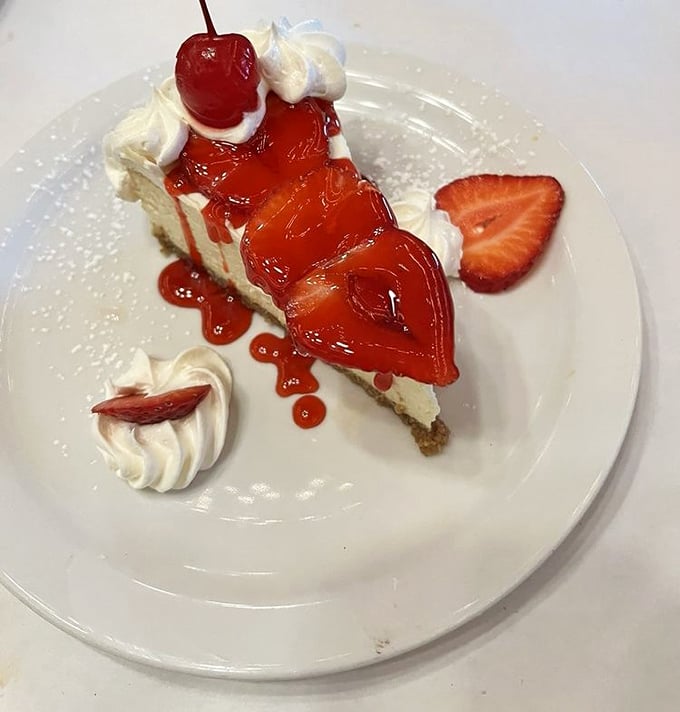 This isn't just cheesecake &ndash; it's a sweet slice of heaven topped with strawberry sauce that makes nearby diners develop sudden dessert envy.