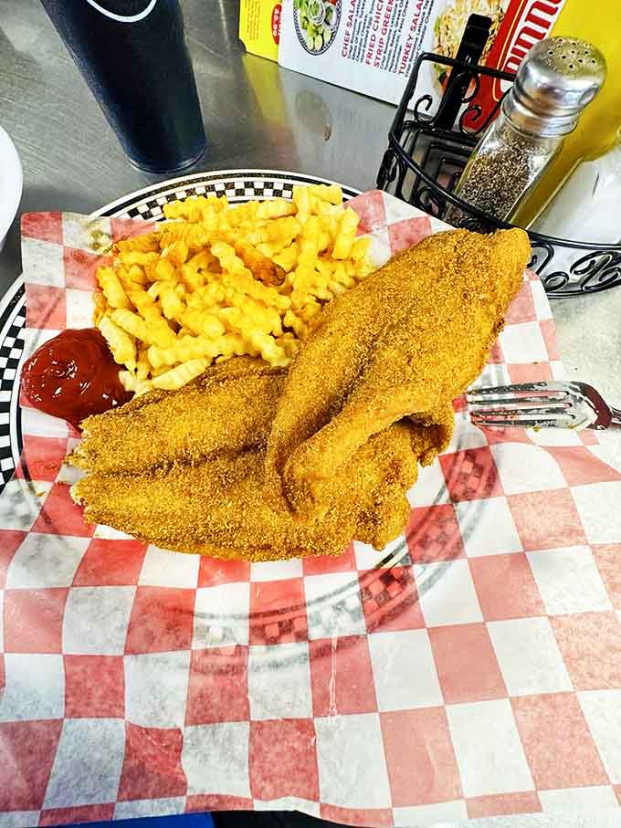 Striped Catfish dinner: Golden-crusted catfish with a perfect crinkle-cut sidekick &ndash; proof that simple food done right never goes out of style.
