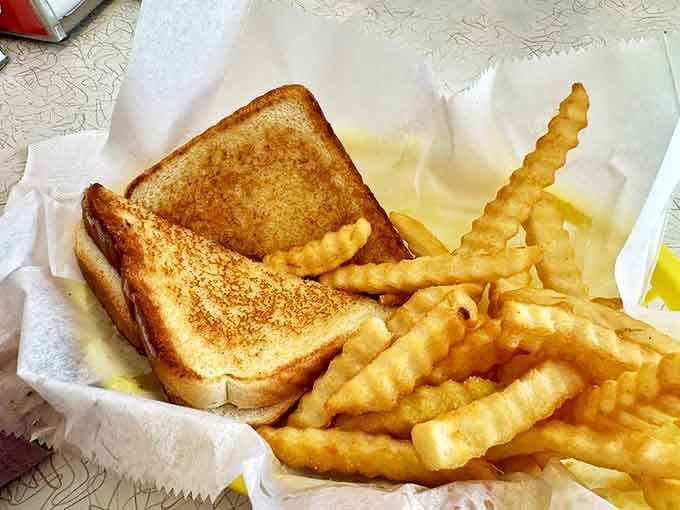 This isn't just any grilled cheese – it's childhood on a plate, with perfectly melted American cheese between golden-brown slices of buttery goodness.