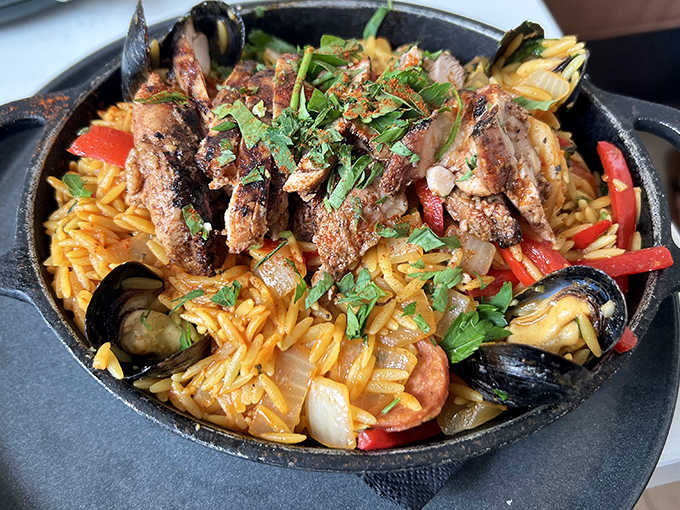 This isn't just paella, it's a celebration in a pan! Saffron-scented rice cradles perfectly cooked seafood in a dish that brings Spanish coastal magic to Illinois.