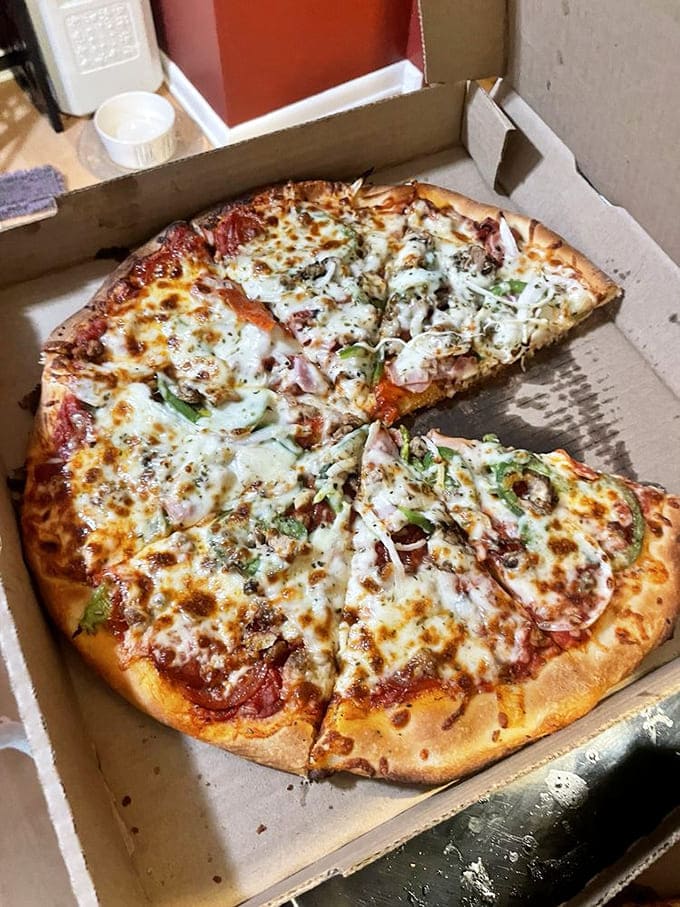 The Wizard pizza arrives looking like edible magic, with toppings generously scattered across that golden deep-dish crust.