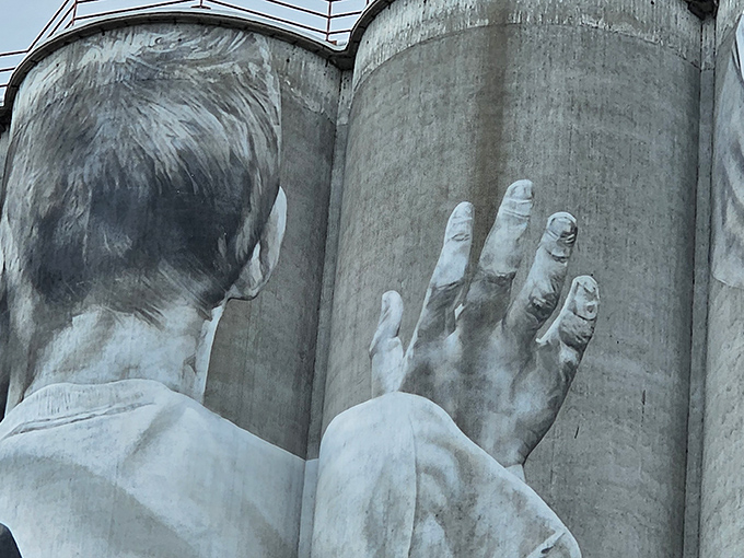 Intricate details like this hand demonstrate the artist's remarkable technical skill&mdash;imagine painting with such precision while suspended 100 feet above ground!