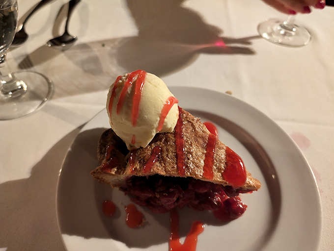 This isn't just dessert—it's a warm cherry pie that makes time stand still, topped with ice cream melting into sweet surrender.