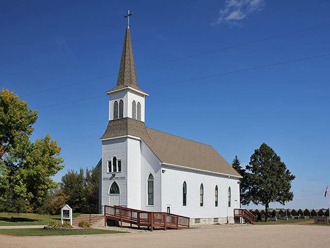 Trinity Lutheran Church stands pristine against Minnesota skies, its white steeple reaching skyward like the town's own spiritual rocket ship.