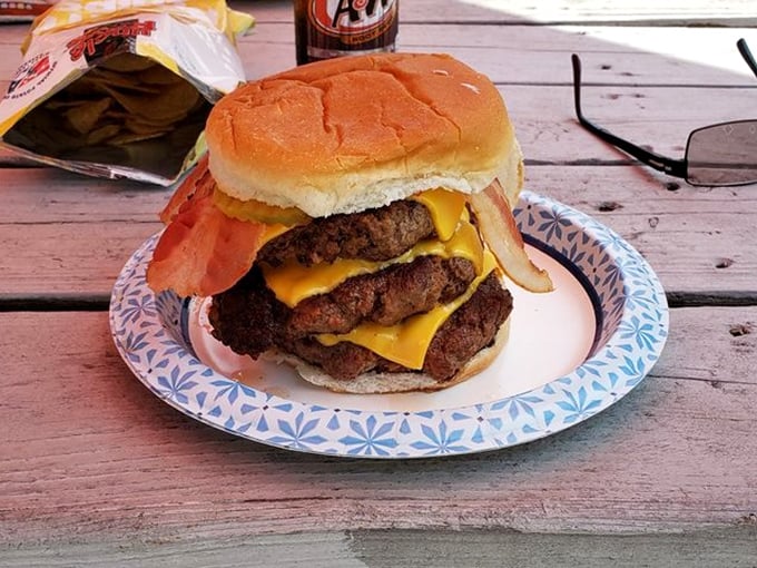 This triple-decker masterpiece isn't just a burger, it's an engineering marvel that somehow stays together until the last bite.
