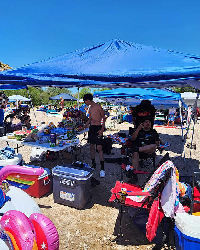 Weekend warriors stake their claim with colorful canopies and coolers, transforming the shoreline into a vibrant community gathering spot.