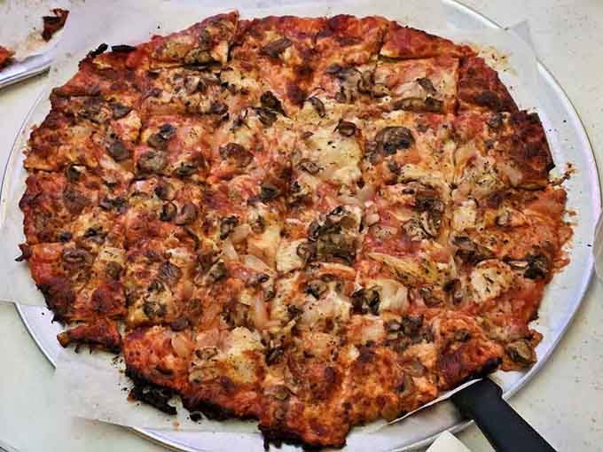 A masterpiece of balance &ndash; this thin-crust pizza with mushrooms showcases the perfect ratio of crispy crust to savory toppings.