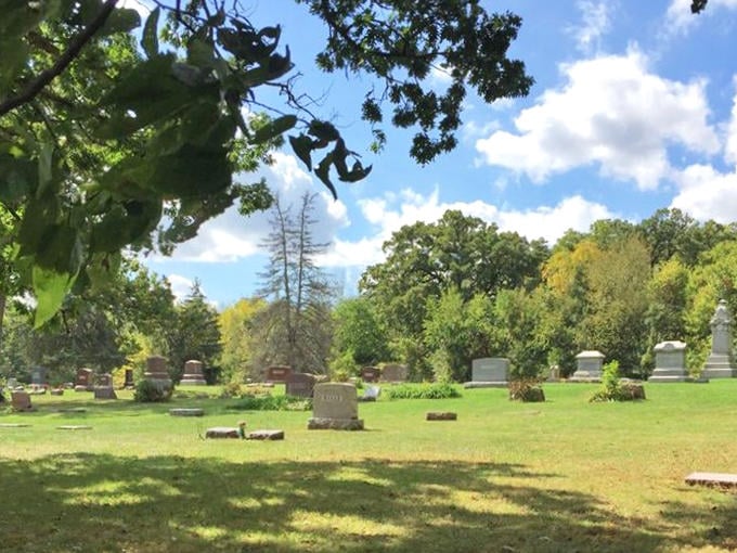 Sunlight dapples across the peaceful grounds, creating a patchwork of light and shadow that dances among the silent stones.
