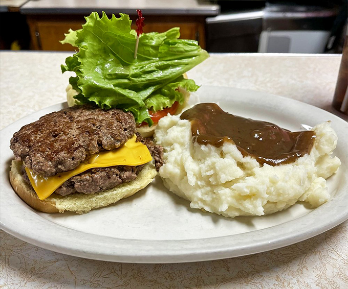 Wimpy burger platter: Two perfectly seasoned beef patties with melted cheese meet their soulmate – a cloud of mashed potatoes swimming in gravy that could make a grown man weep.