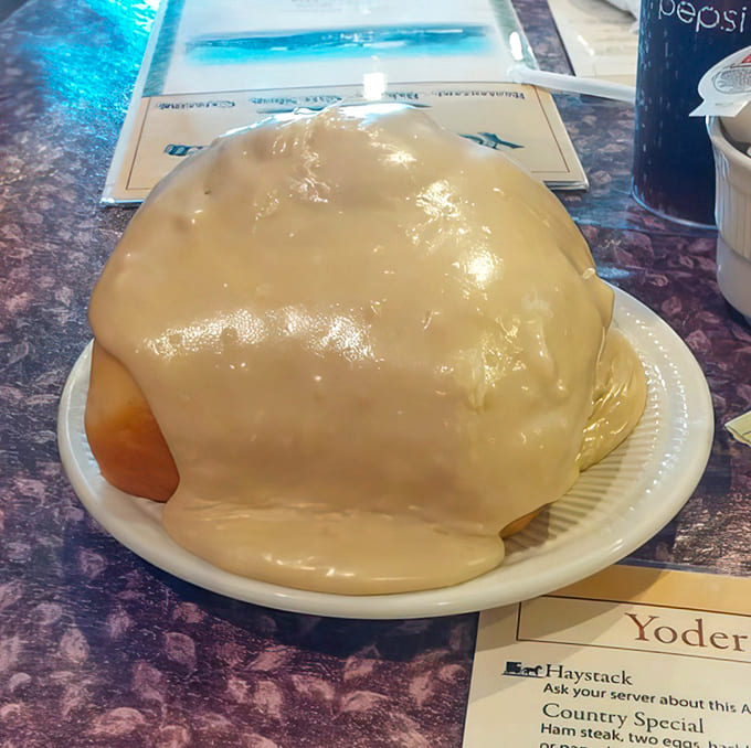 Behold the legendary cinnamon roll in all its glory, a pastry so massive it defies logic and delights everyone who dares.
