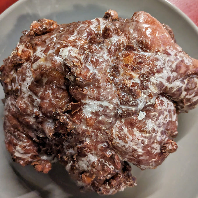 Behold the apple fritter in all its glory, a pastry so substantial it practically requires a forklift and definitely demands respect.