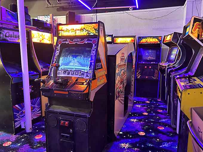 Rows of arcade cabinets create a digital playground where time stands still and high scores are the only currency that matters.