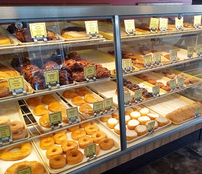 Behold the glass case of dreams, where each shelf offers a different path to pastry nirvana.