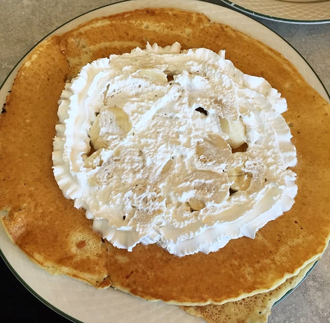 This isn't just a pancake &ndash; it's a fluffy golden cloud topped with a heavenly dollop of whipped cream that's practically begging for your fork.