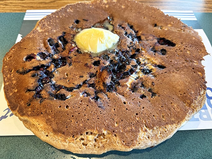 This blueberry pancake isn't just breakfast &ndash; it's an edible frisbee of joy with a perfect golden crust and wild berries hiding in every bite. 
