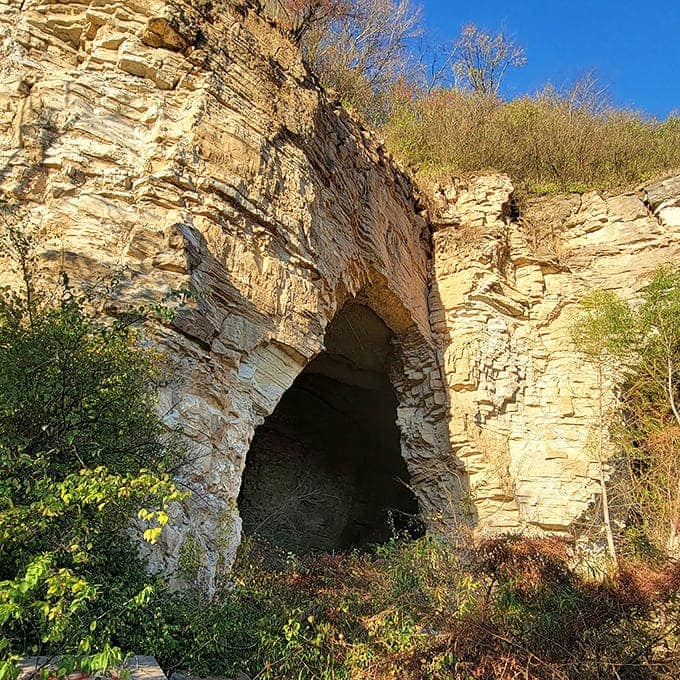 Nature's own cathedral entrance, where limestone has been carved by millennia of patient water, creating doorways to underground worlds.