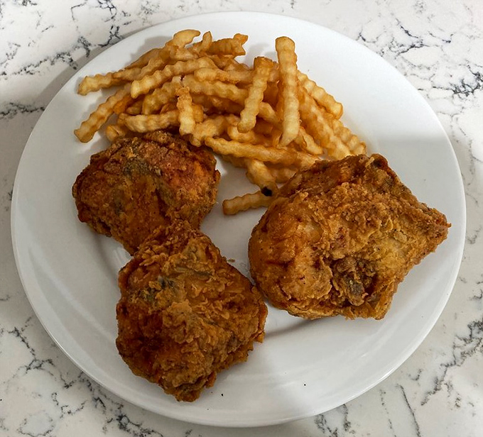 Golden-brown perfection on a plate. Each piece of chicken wears its crunchy, seasoned armor like a badge of honor.