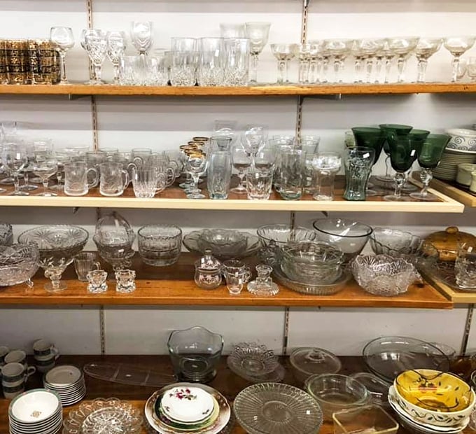 Crystal, cut glass, and vintage stemware sparkle under fluorescent lights &ndash; each piece silently telling stories of celebrations past.