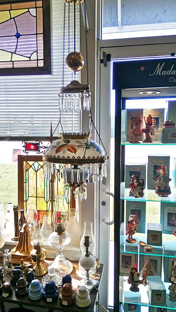 This hanging oil lamp with painted glass shade and crystal prisms once illuminated someone's Victorian parlor &ndash; now it awaits a new home.